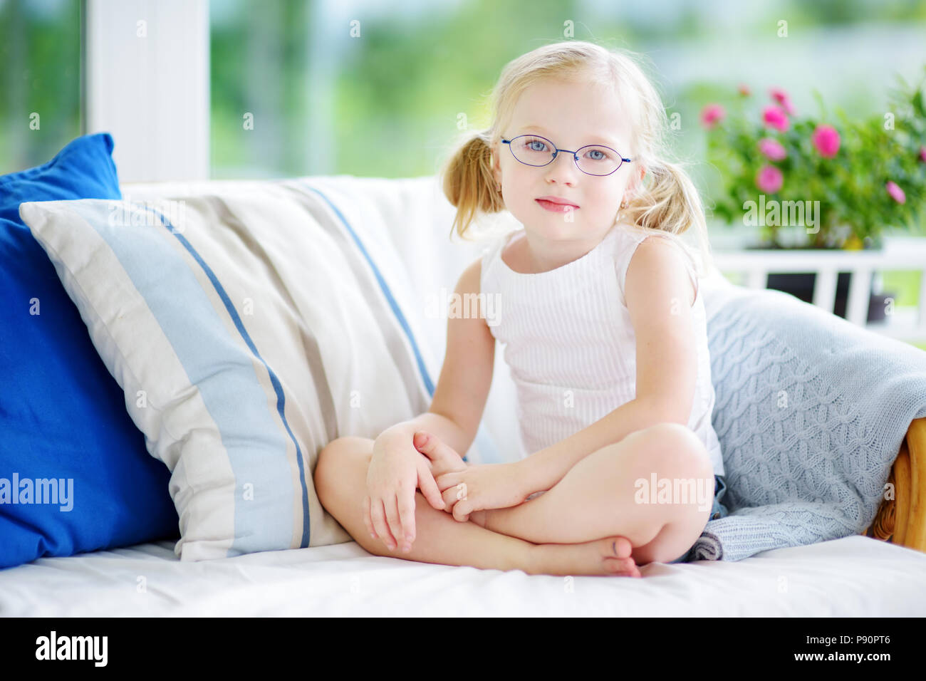 Portrait of beautiful little girl wearing glasses at home. Vision ...
