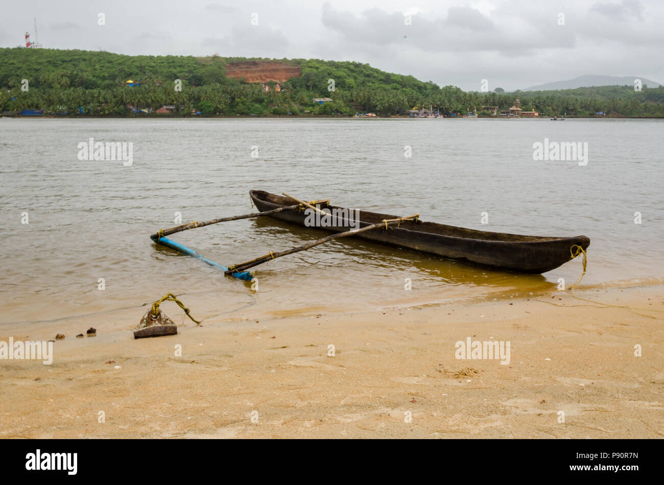 Wooden canoe anchored at the shore of Betul beach, Cavelossim, Goa ...
