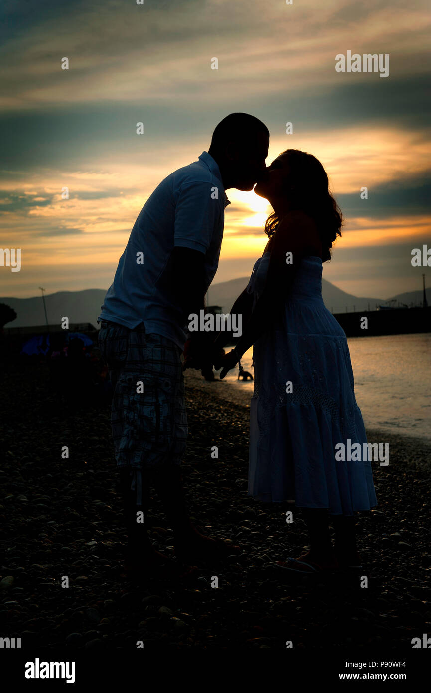 Silhouette of a couple on the beach Stock Photo - Alamy