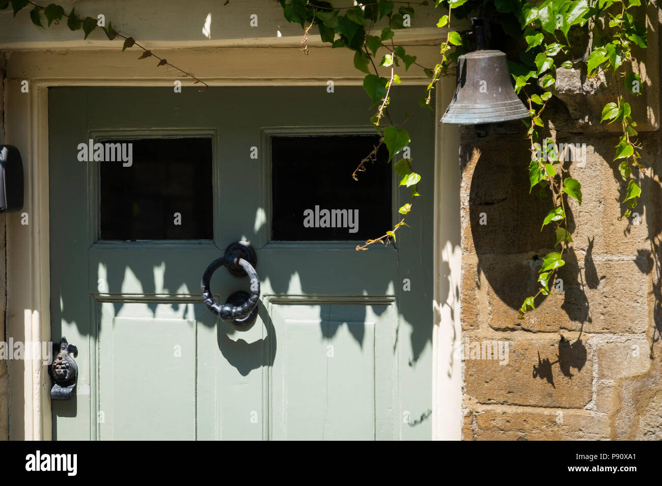 A Traditional door bell and knocker Stock Photo - Alamy