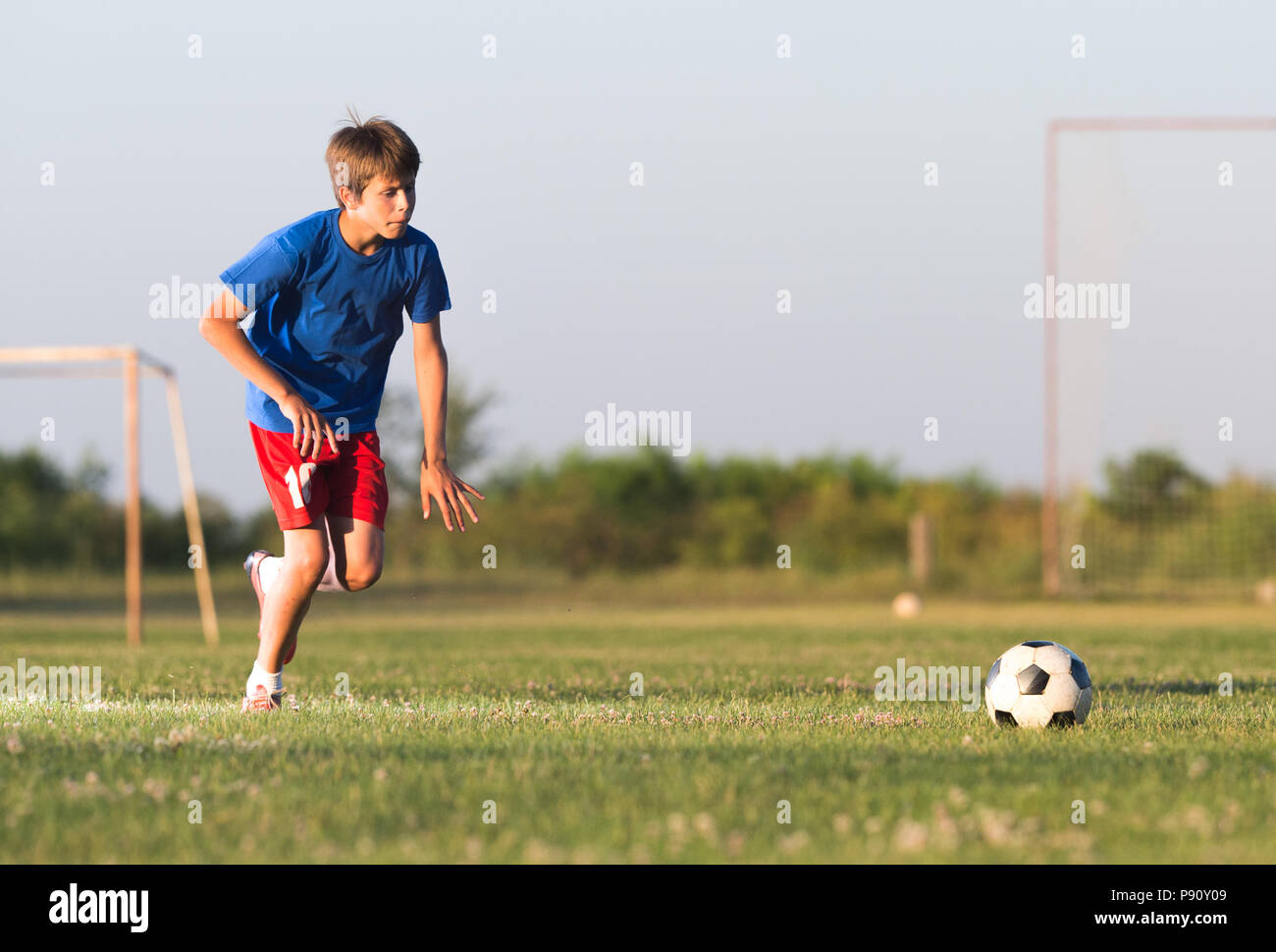 Young boy playing football Stock Photo - Alamy Young boy playing football Stock Photo - Alamy