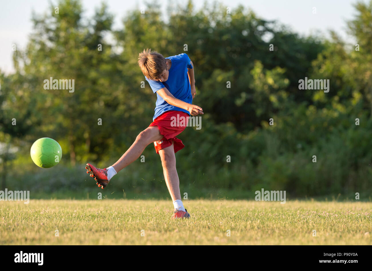 Young boy playing football Stock Photo - Alamy