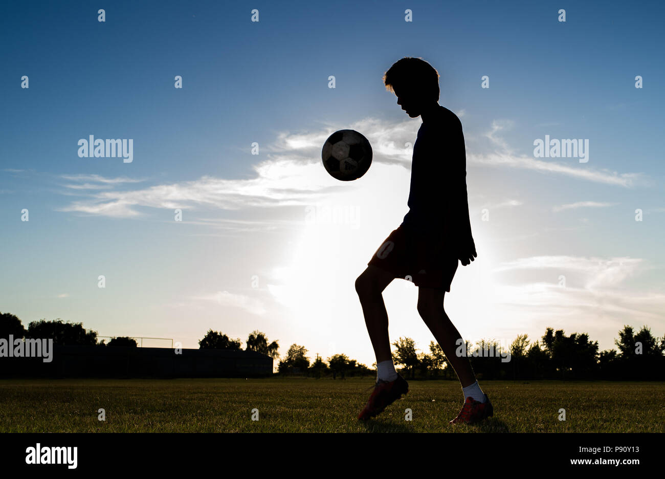 Young boy playing football Stock Photo - Alamy Young boy playing football Stock Photo - Alamy