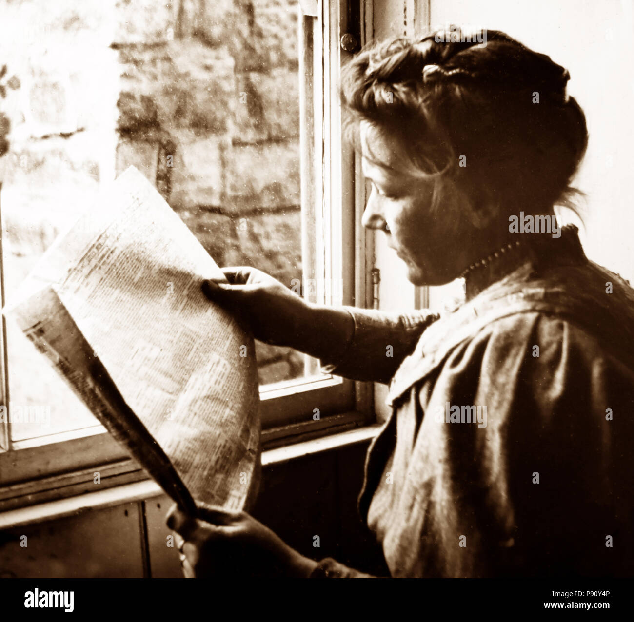 Lady reading newspaper, early 1900s Stock Photo - Alamy