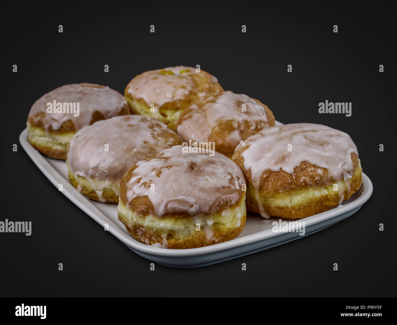 Traditional Polish donuts with icing over black background Stock Photo ...