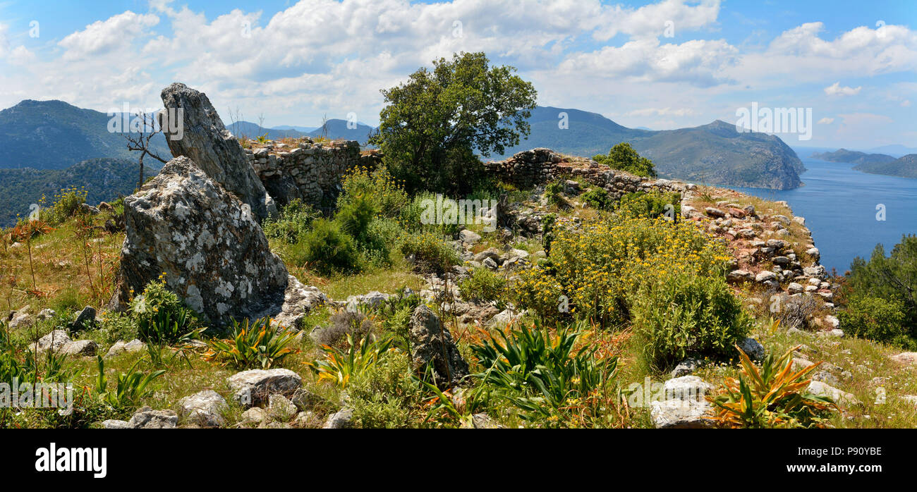 Ruins of Hydas castle topping a hill above Selimiye bay and Turgut ...