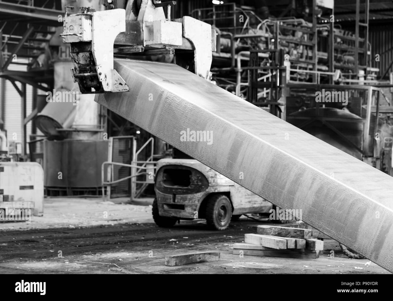 aluminum slab just melted and stacking by a huge crane on the floor ...