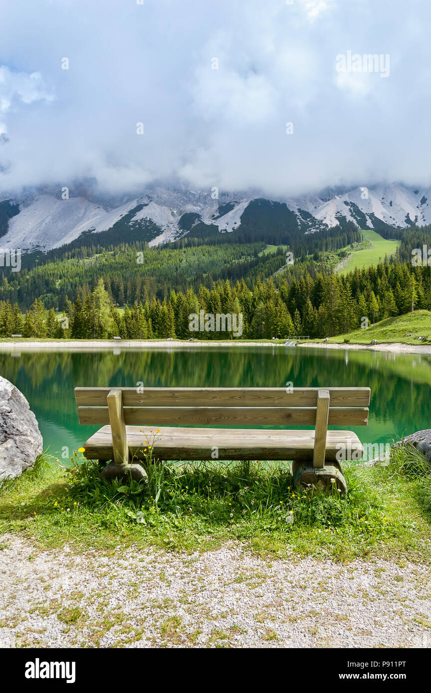 Bench near Almsee lake in the Alps mountains - Tyrol, Austria ...