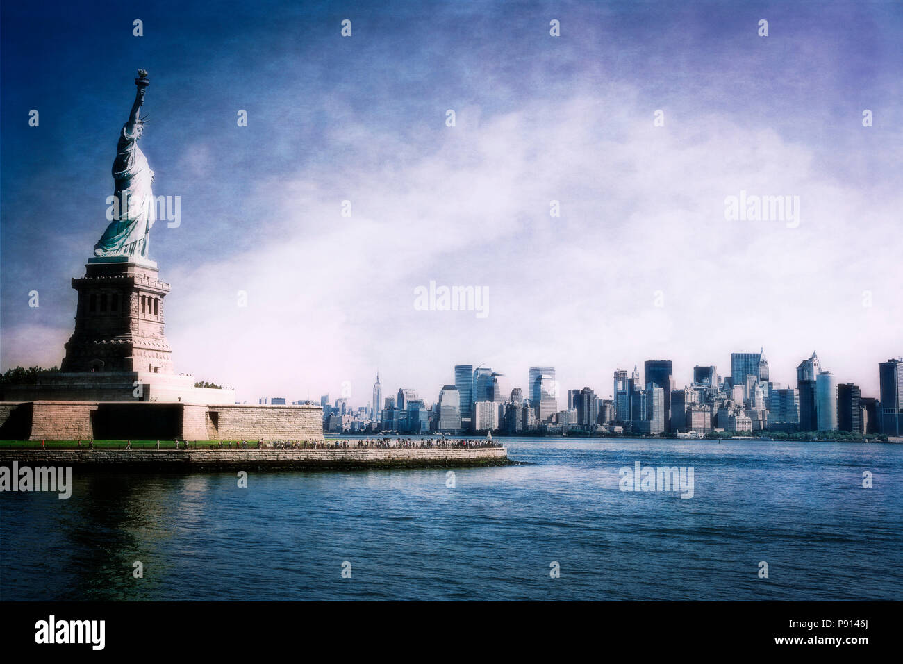 Liberty Island and the Statue of Liberty frames lower Manhattan, New ...