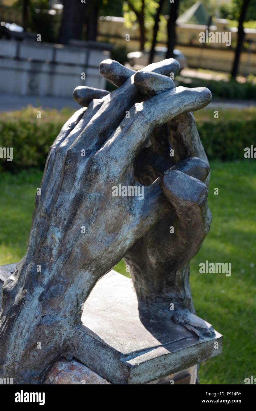 Hands crossed statue Stock Photo - Alamy