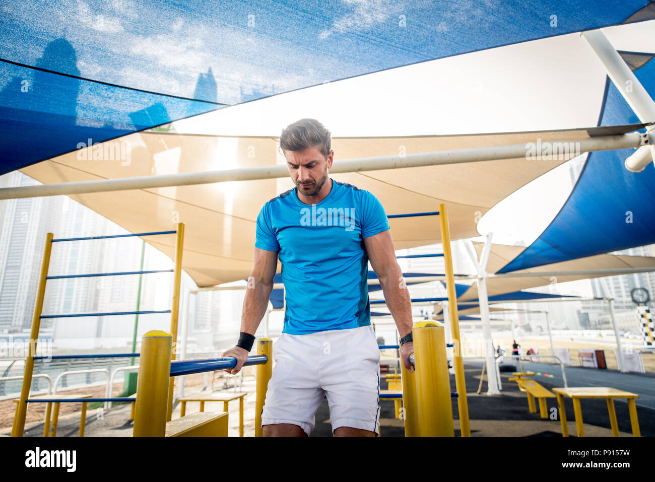 Young athletic man training outdoors - Young adult doing a fitness ...