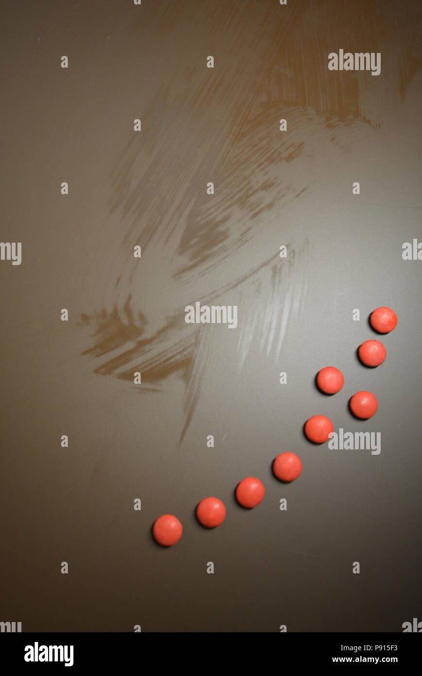 Matte beautiful sweets, shivering candy red on a brown matte background ...