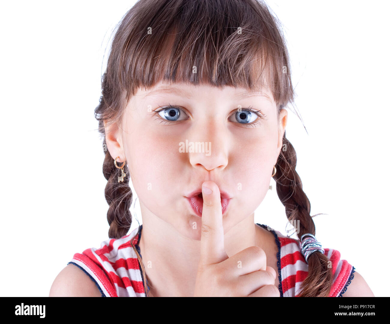Portrait of funny lovely little girl with her Finger to her Mouth ...