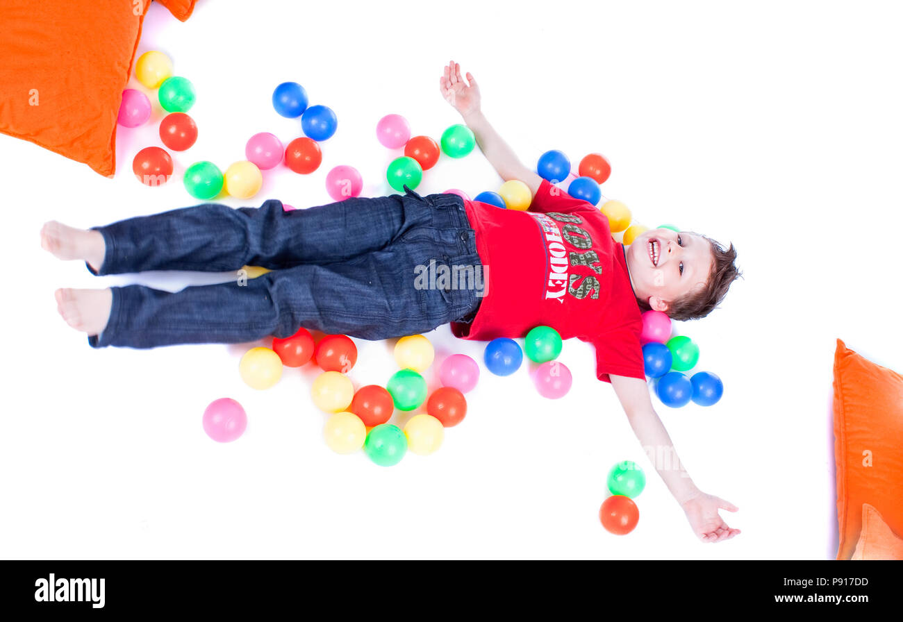A lovely kid is playing with balls, studio shot Stock Photo - Alamy