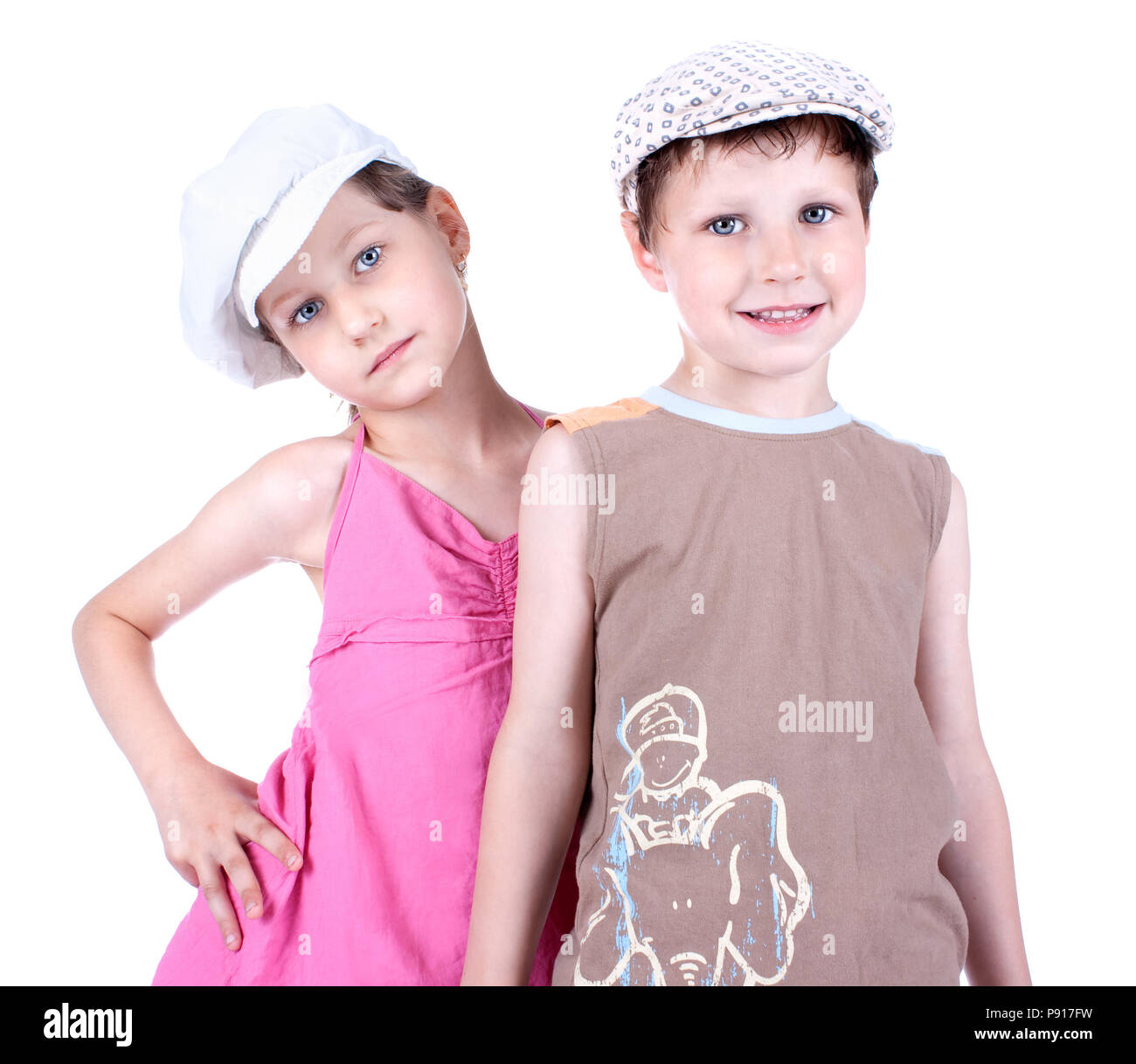 Cute blue-eyed children with whit caps posing in studio Stock Photo - Alamy