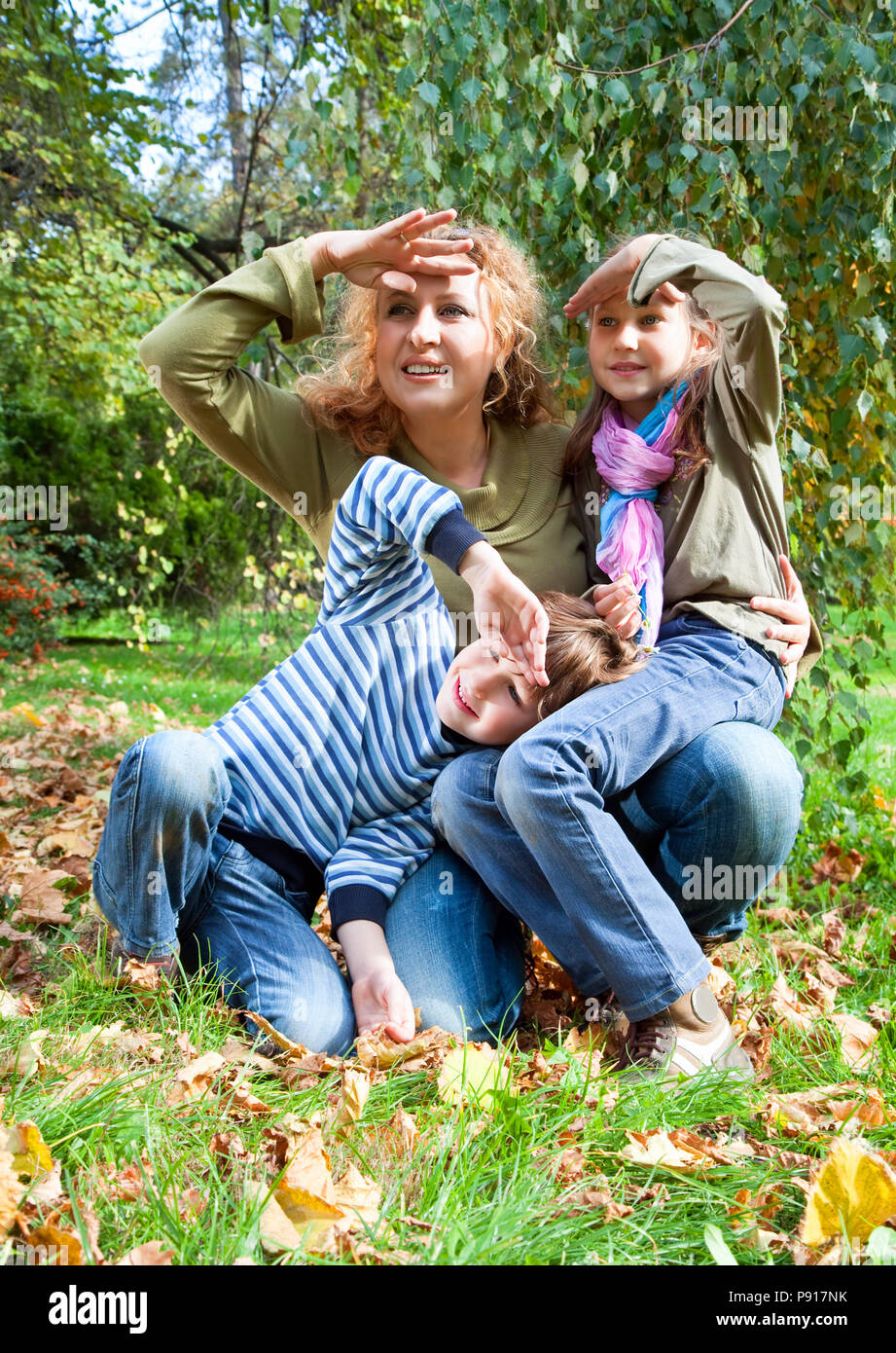 Happy Family Relaxing Outdoors In Autumn Landscape Stock Photo - Alamy