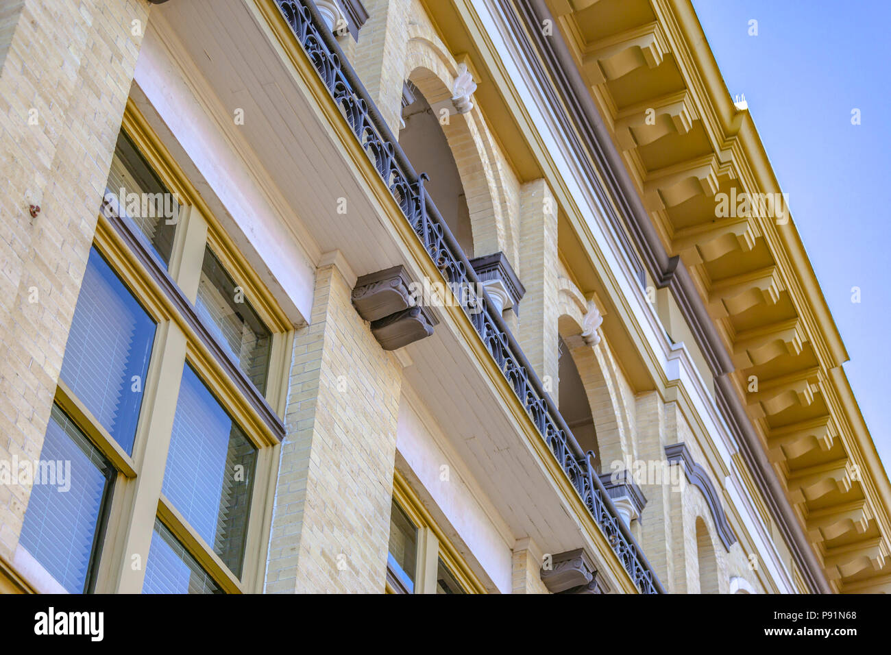 Building exterior with windows seen form sidewalk Stock Photo - Alamy