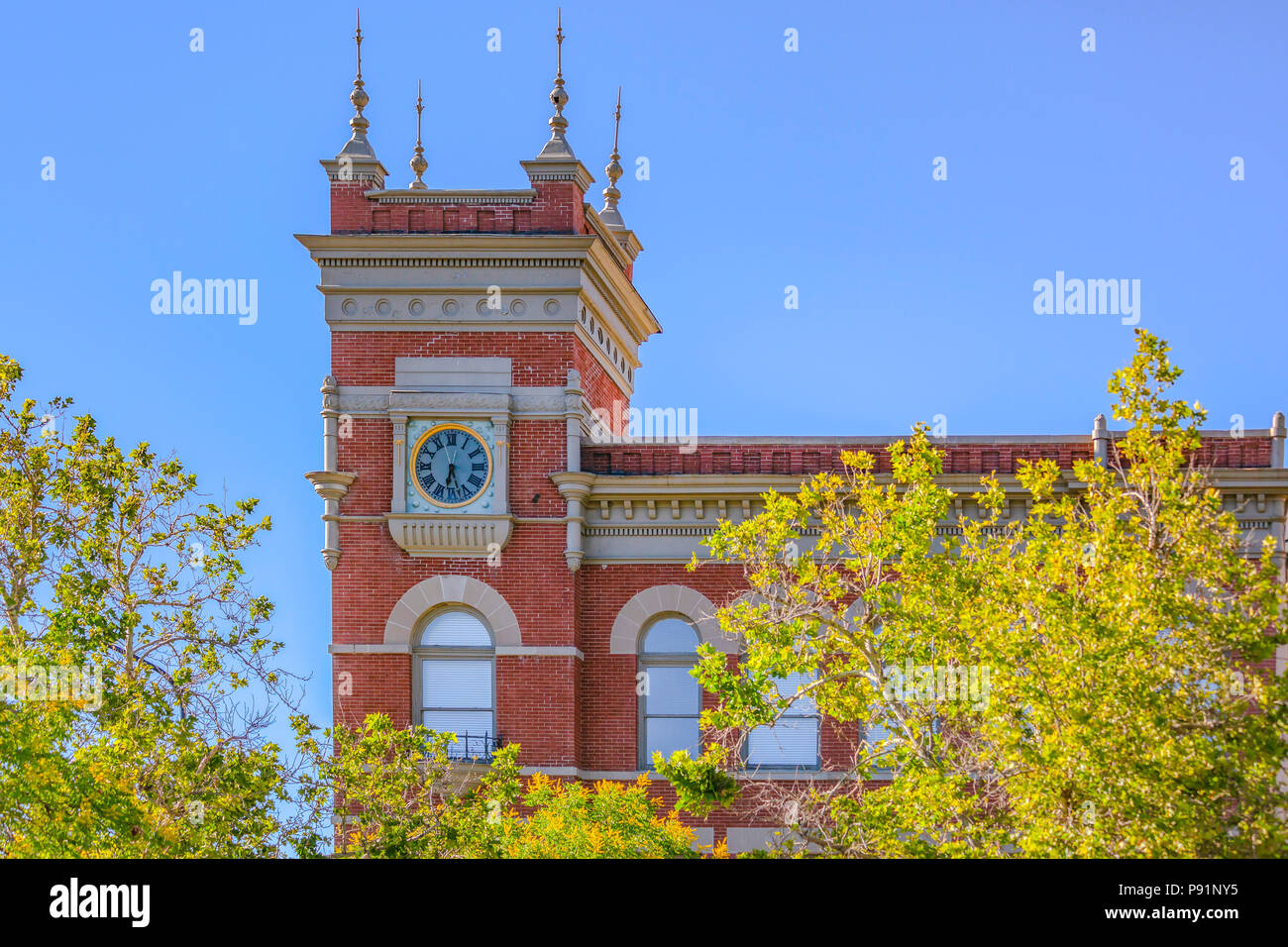 Clock tower on corner of building Stock Photo - Alamy