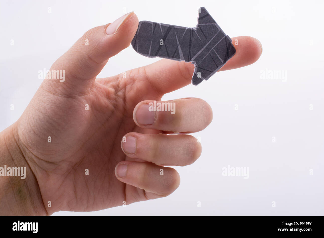 Hand holding a black arrow on a white background Stock Photo - Alamy