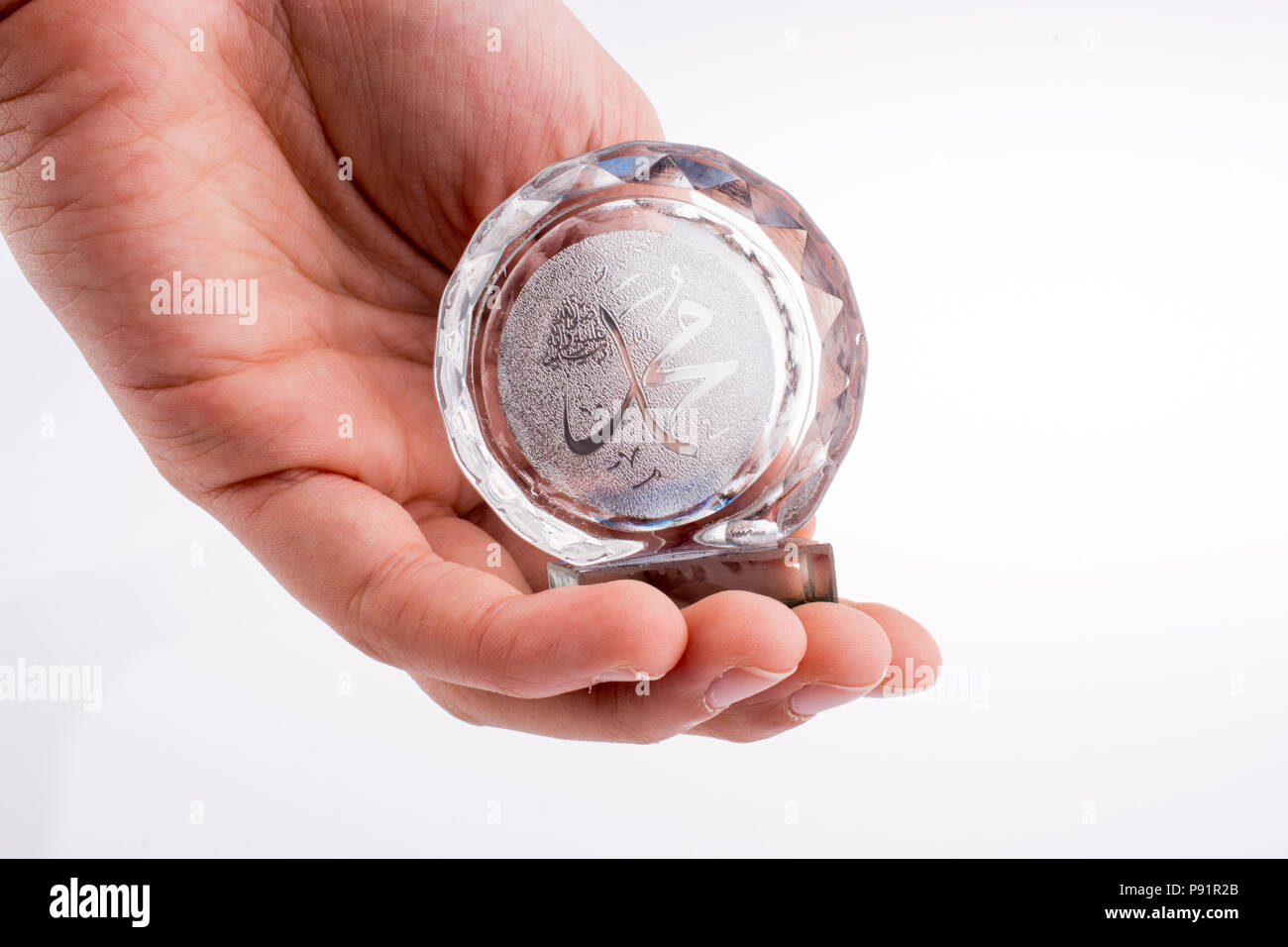 Hand holding Miniature Holy Quran on a white background Stock Photo - Alamy