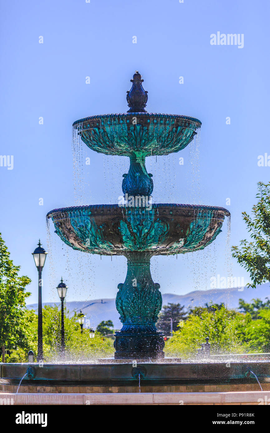 Copper fountain in formal garden with lamps Stock Photo - Alamy
