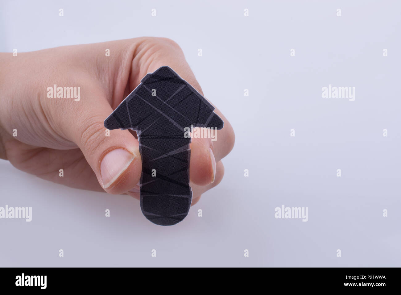Hand holding a black arrow on a white background Stock Photo - Alamy