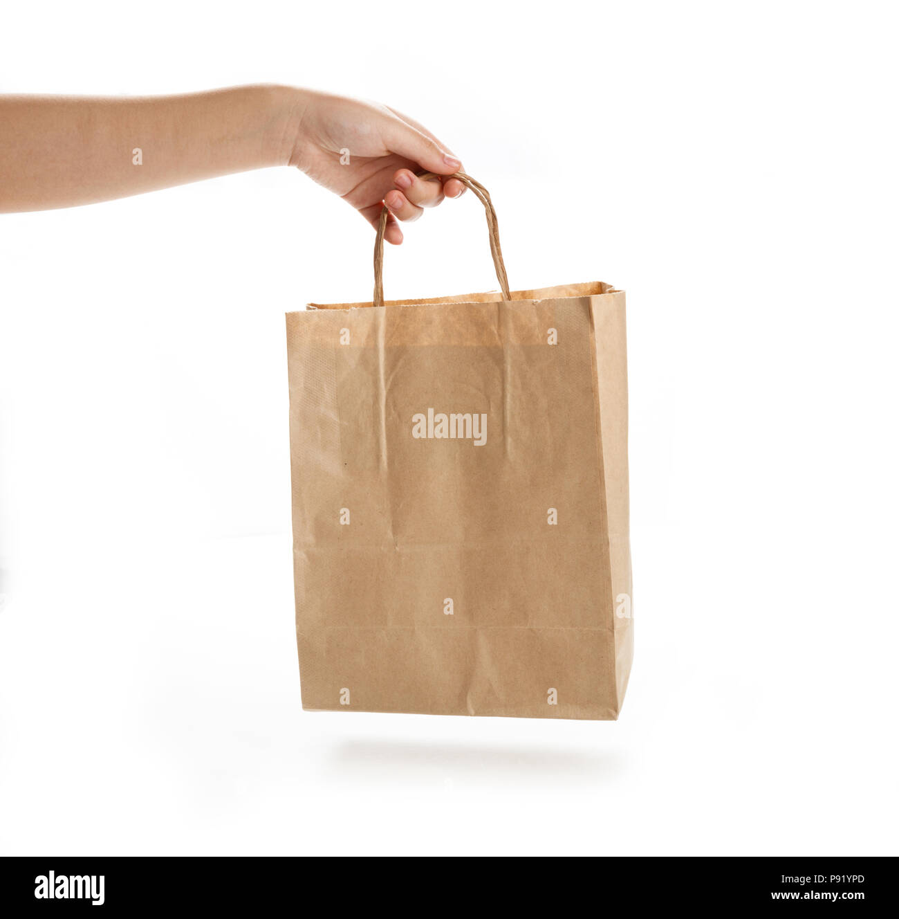 Brown paper bag on white background. close up shot Stock Photo - Alamy