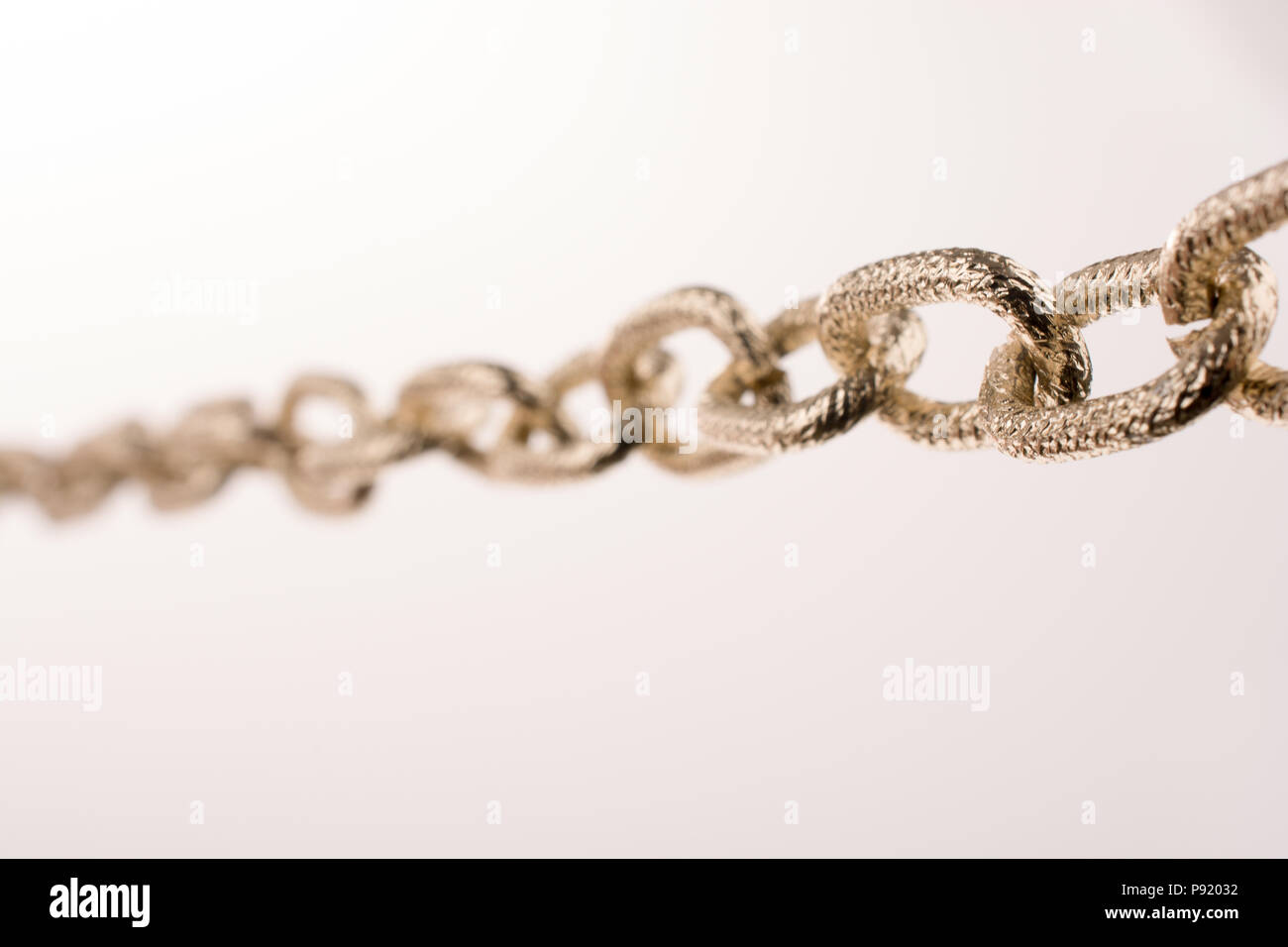 gold color metal chain on white background Stock Photo - Alamy