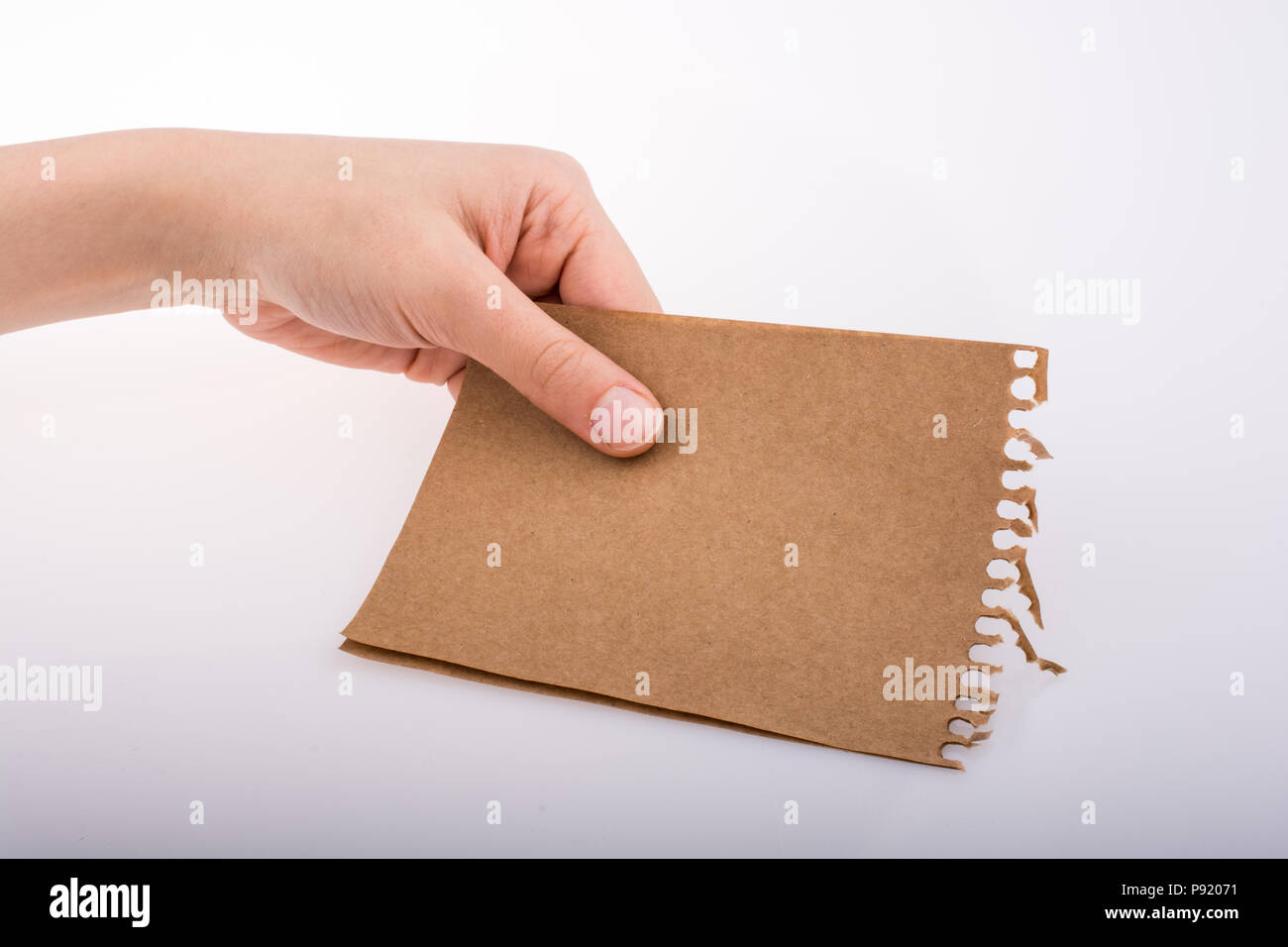 Hand holding a sheet of paper on a white background Stock Photo - Alamy