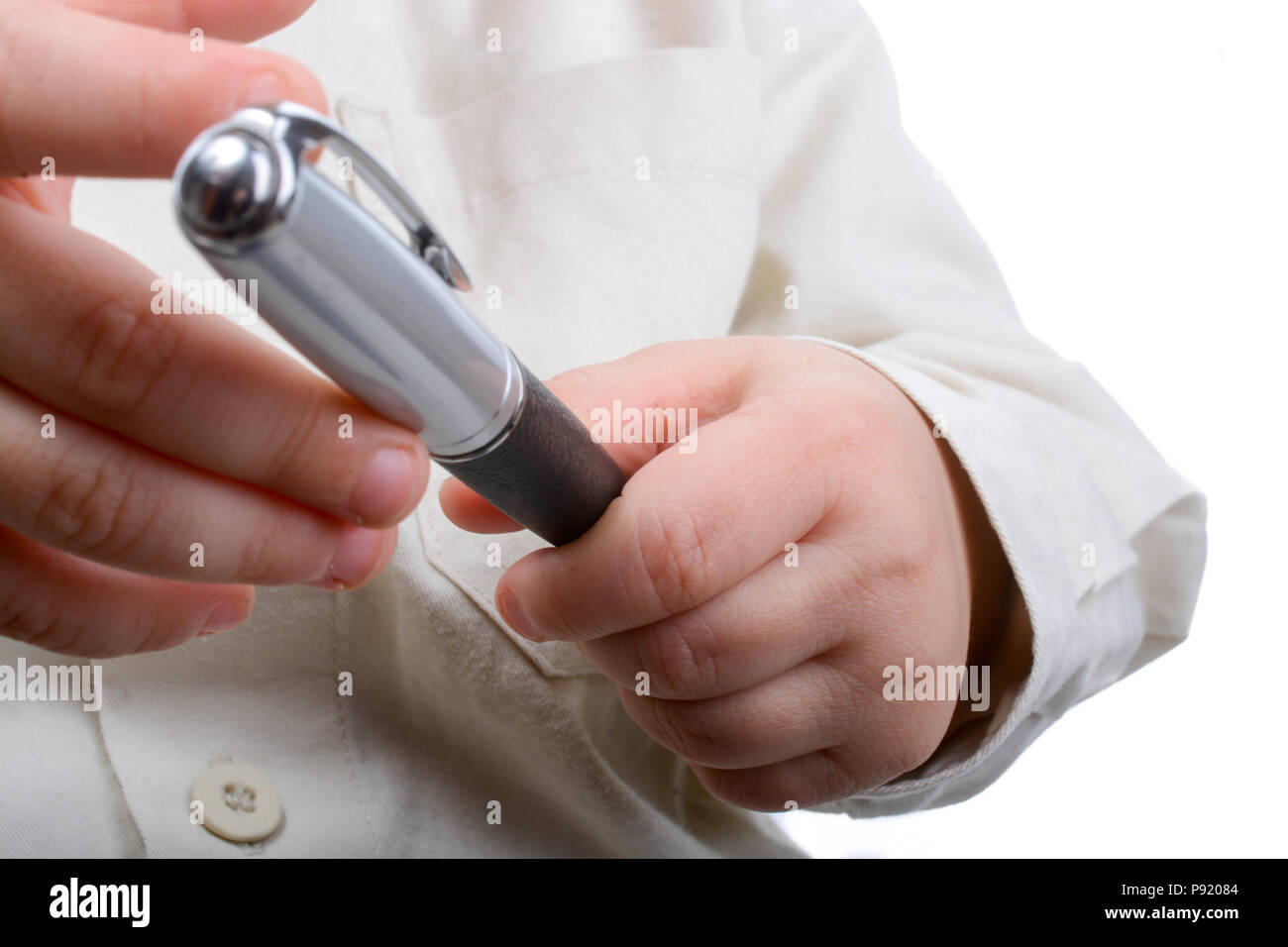 Baby holding a pen in his hand on a white background Stock Photo - Alamy