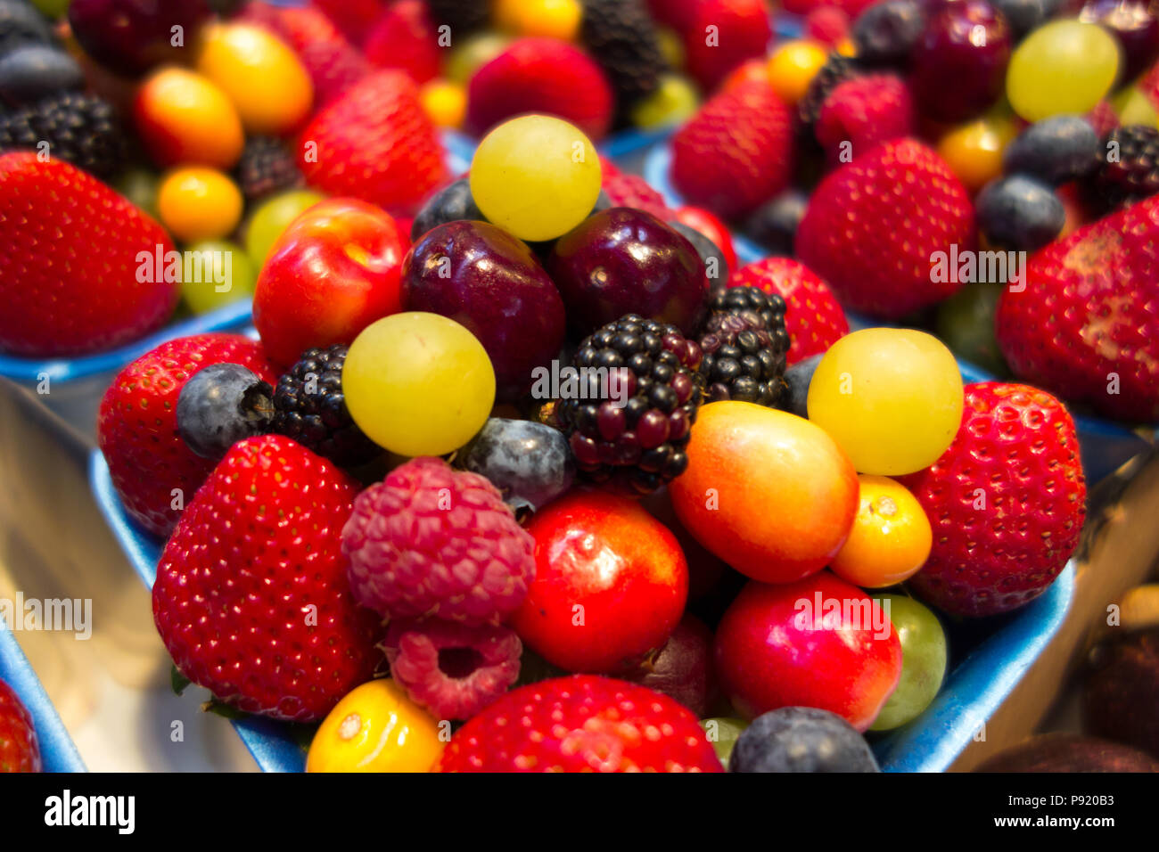 Fresh mixed fruit berries close up background Stock Photo - Alamy