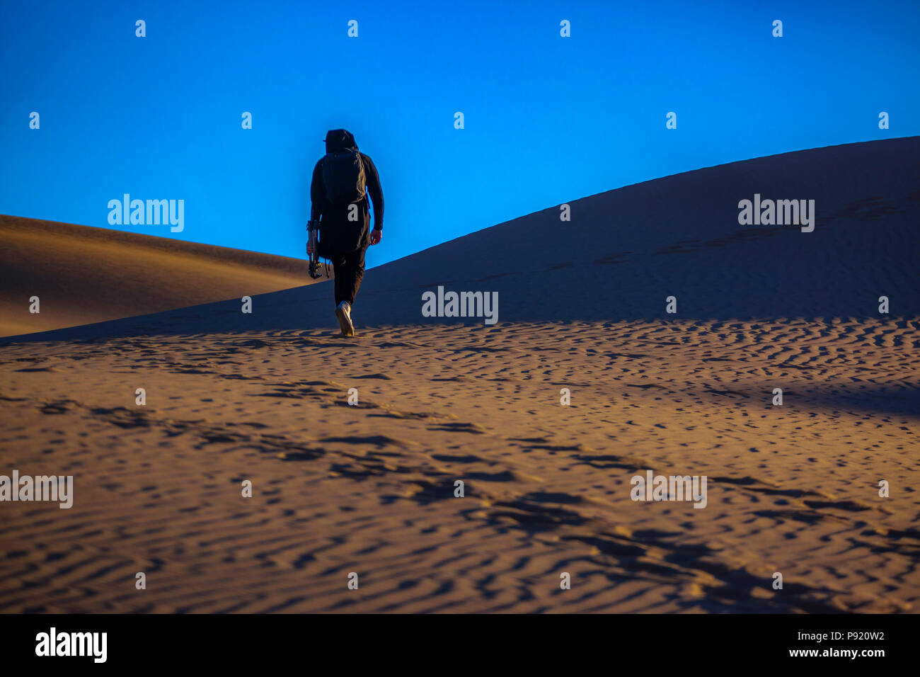 Young man walking sand dune sunset hi-res stock photography and images ...