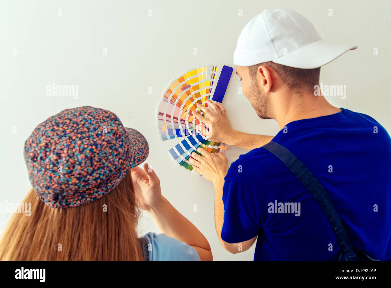 Photo from back side of two person while choosing color from color ...