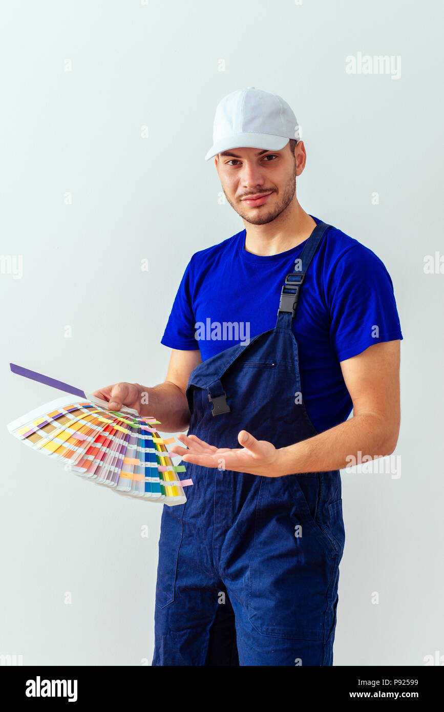 Photo of young man in blue uniform which holds colour palette Stock ...