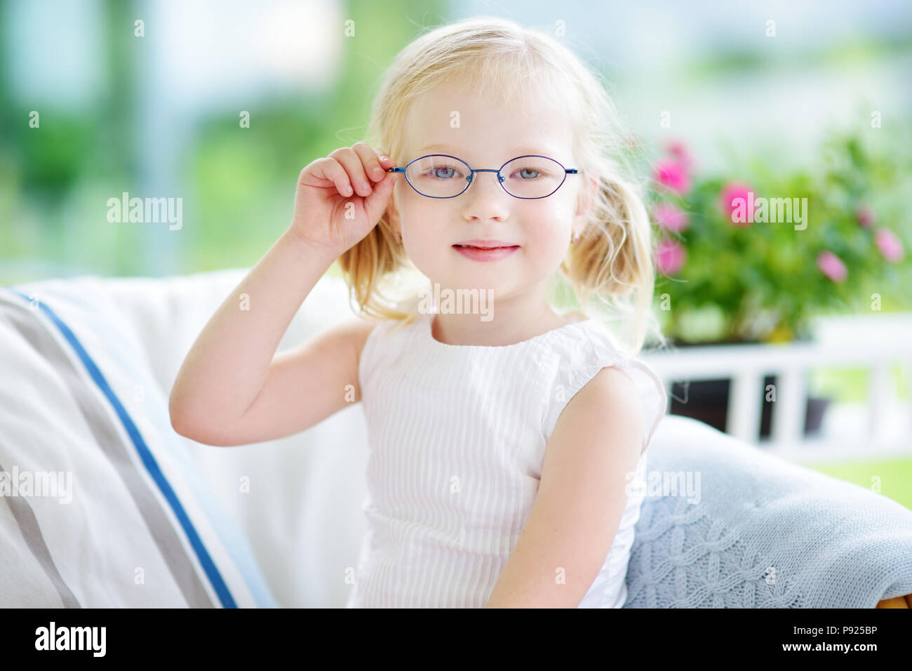 Portrait of beautiful little girl wearing glasses at home. Vision ...