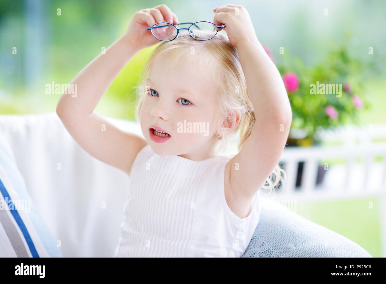 Portrait of beautiful little girl wearing glasses at home. Vision ...