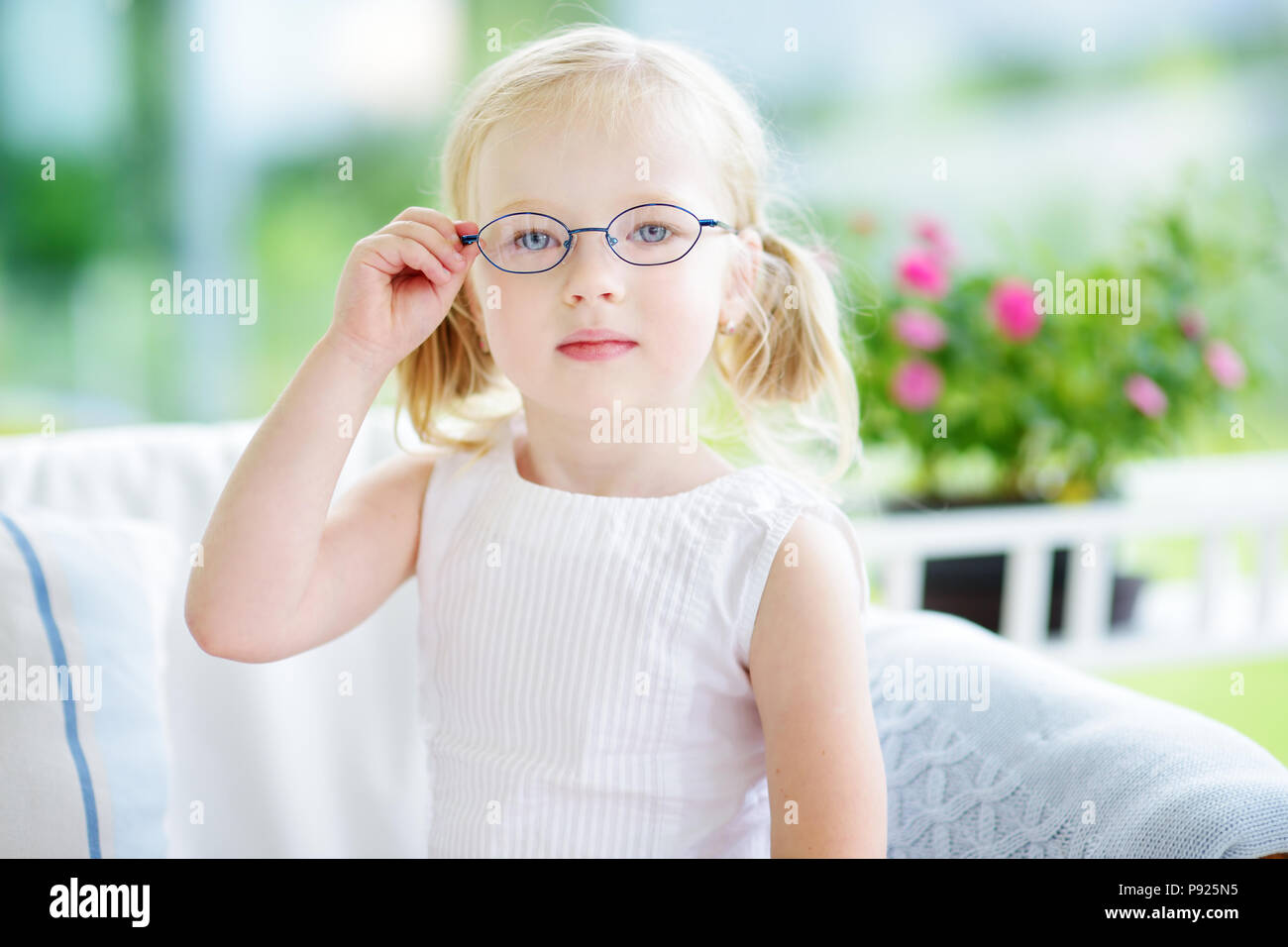 Portrait of beautiful little girl wearing glasses at home. Vision ...