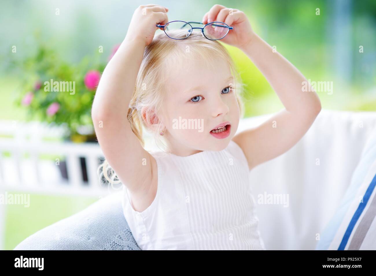 Portrait of beautiful little girl wearing glasses at home. Vision ...