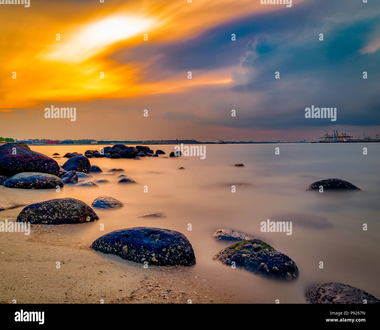 Rocks At Beach During Dusk Stock Photo - Alamy