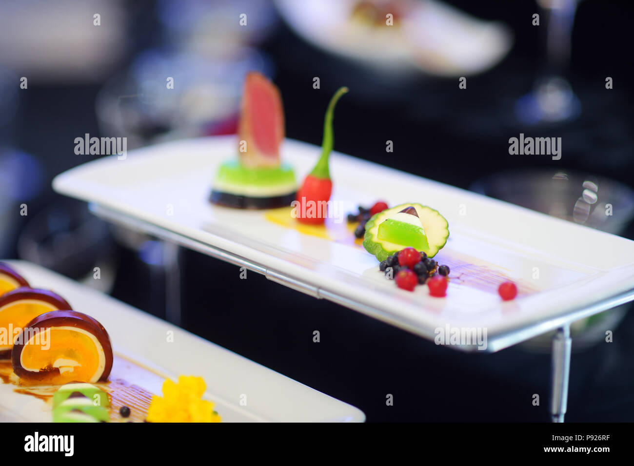 Molecular modern cuisine. Various fancy dishes on white plates in ...