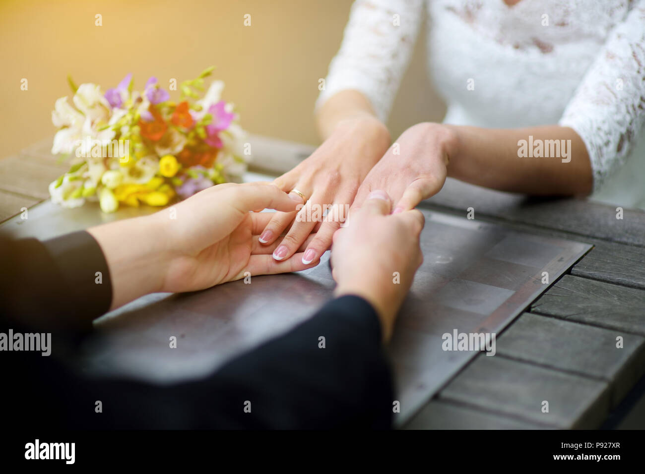 Bride and groom holding their hands on a wedding day Stock Photo - Alamy