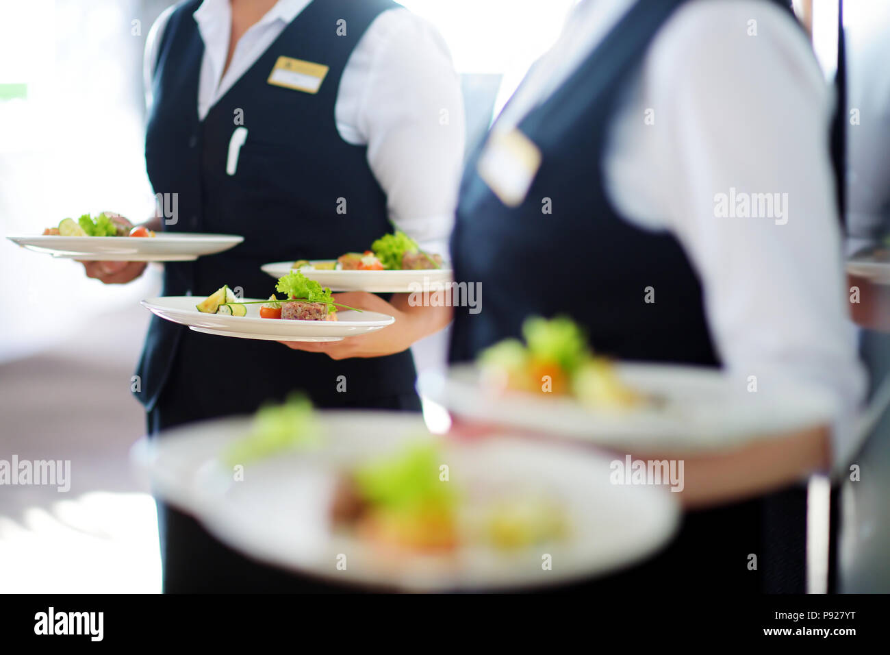Waiter carrying three plates hi-res stock photography and images - Alamy