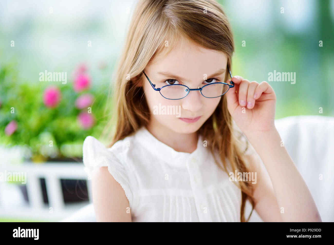 Portrait of beautiful little girl wearing glasses at home. Vision ...