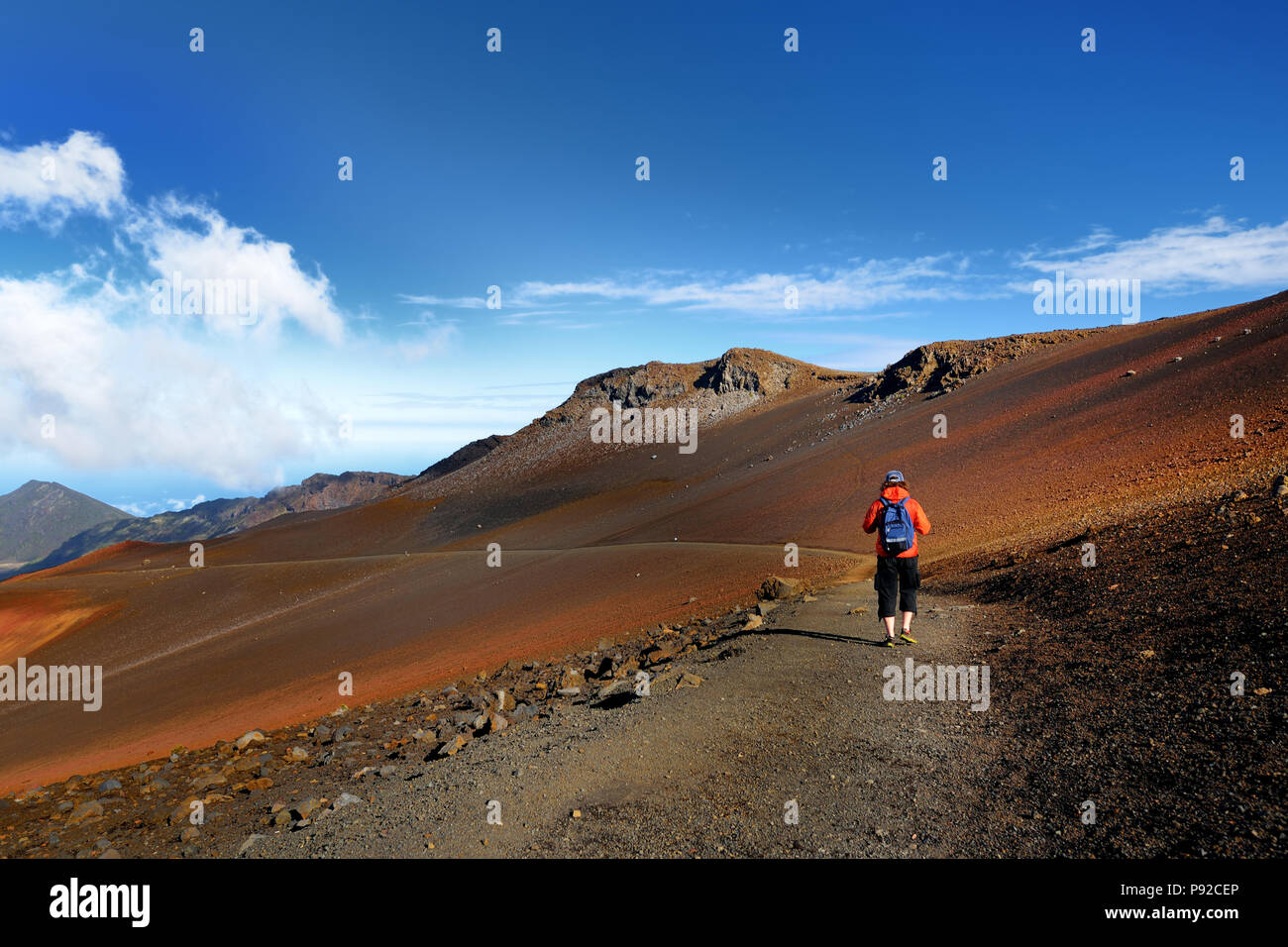 Tourist hiking in Haleakala volcano crater on the Sliding Sands trail ...