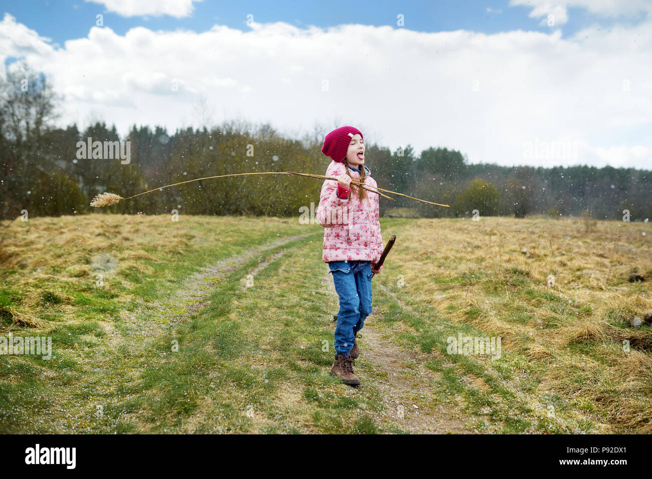 Cute little girl catching first snowflakes with her tongue on chilly ...