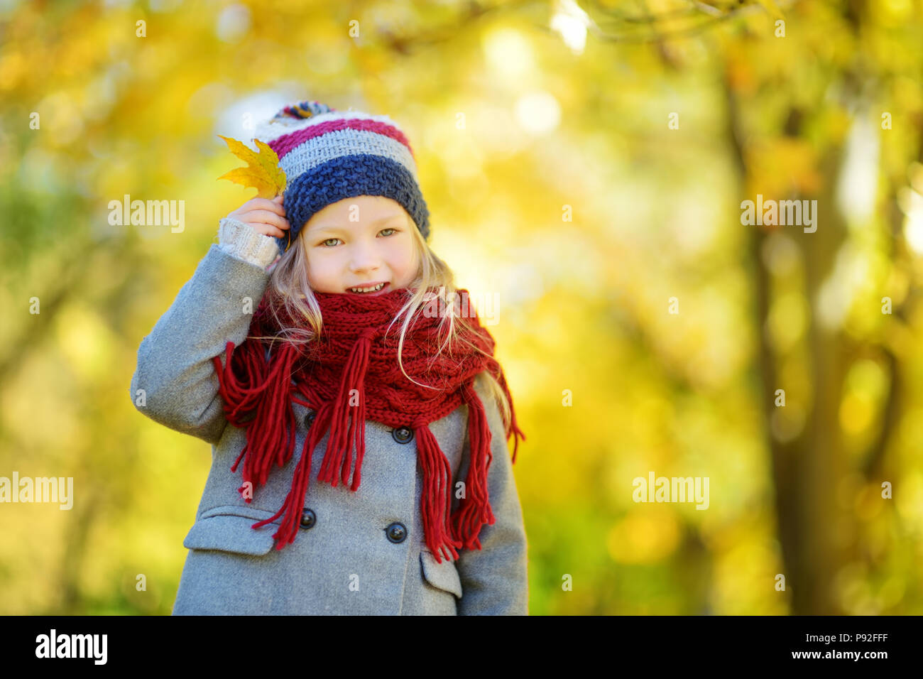 Cute little girl having fun on beautiful autumn day. Happy child ...