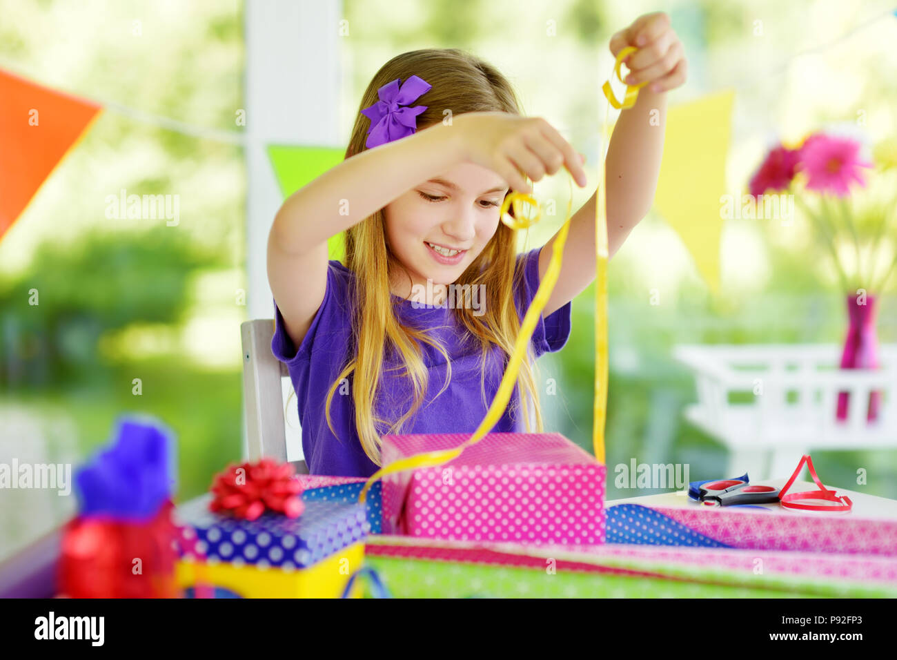 Cute preteen girl wrapping gifts in colorful wrapping paper. Adorable ...