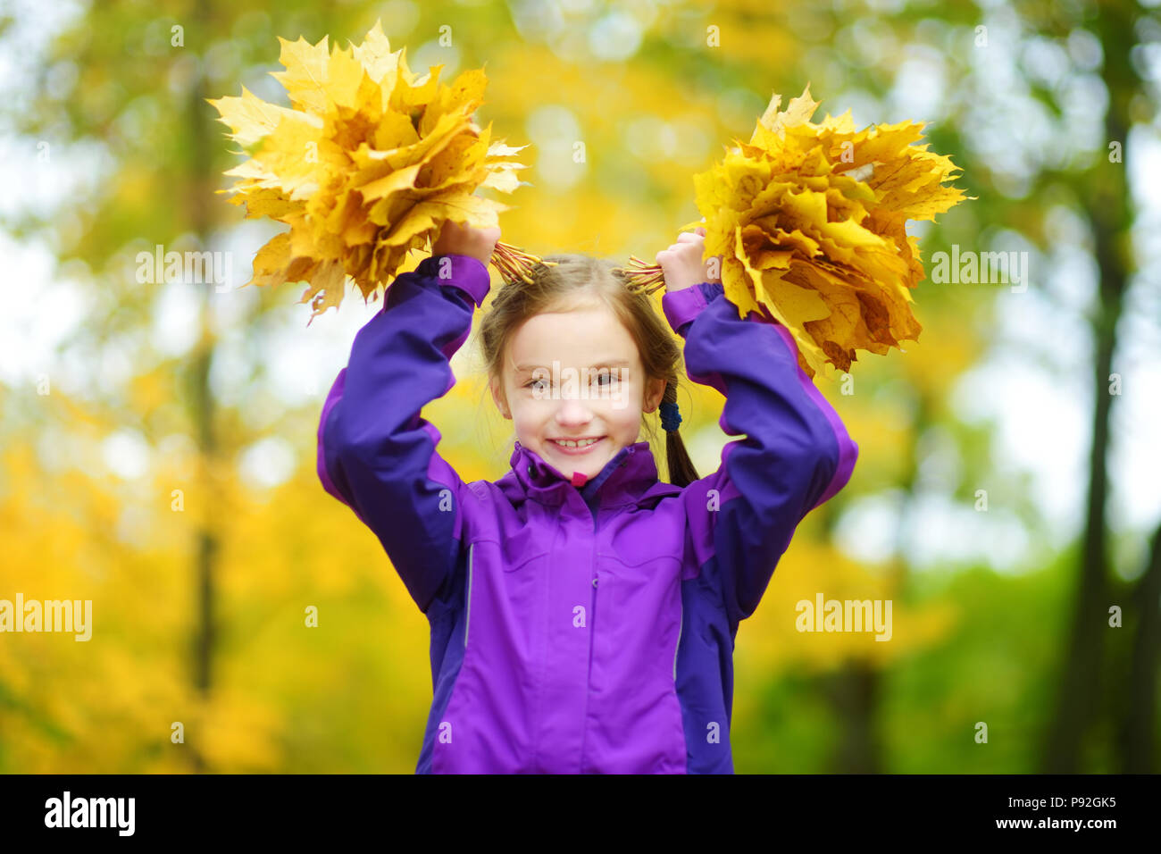 Cute little girl having fun on beautiful autumn day. Happy child ...