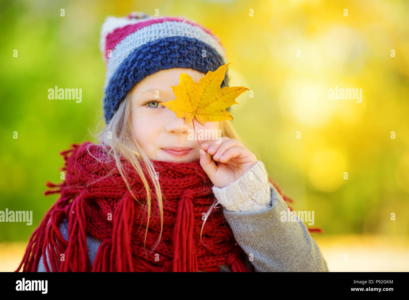 Cute little girl having fun on beautiful autumn day. Happy child ...