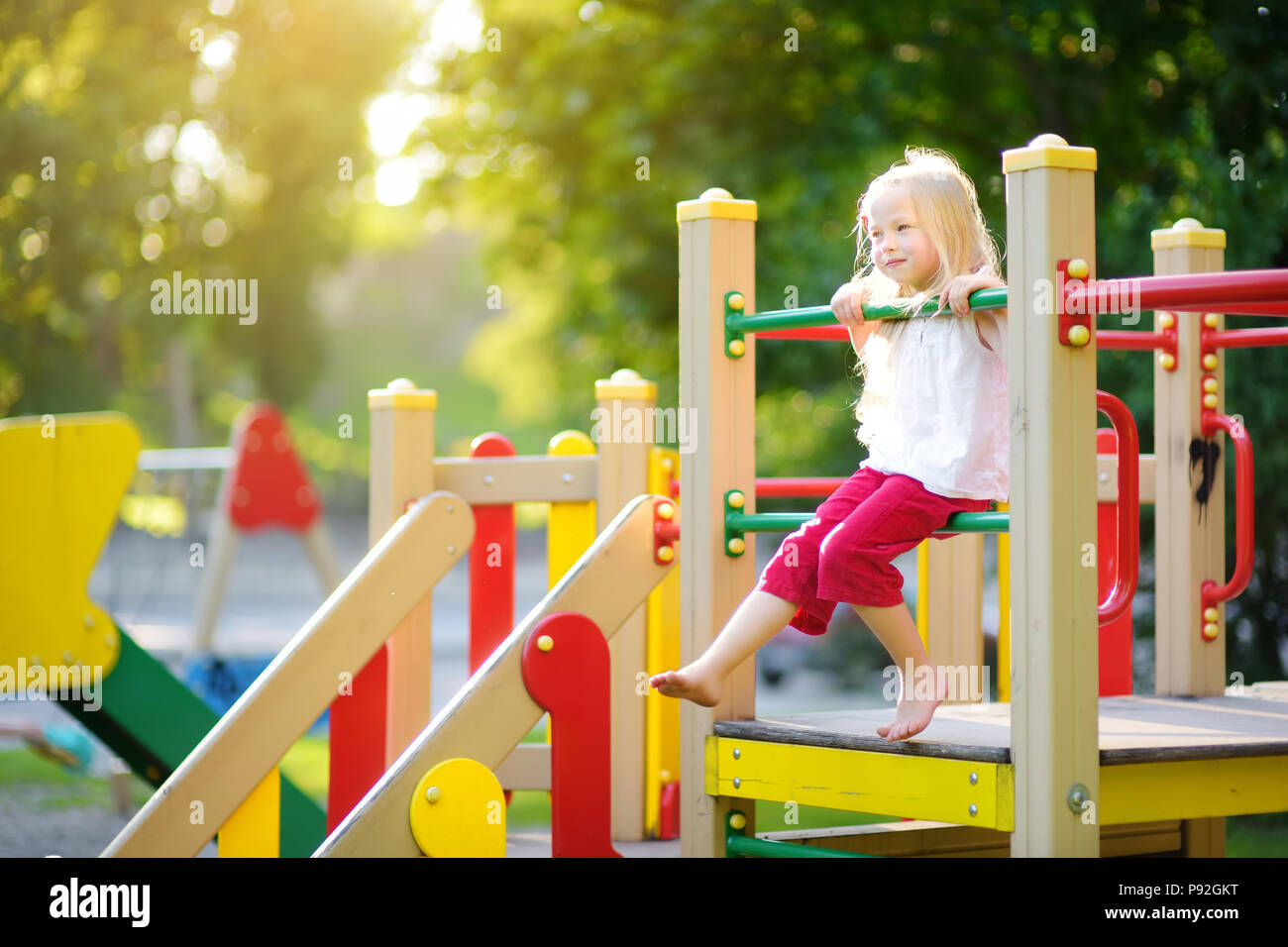 Cute little girl having fun on a playground outdoors in summer. Sport activities for kids Stock ...
